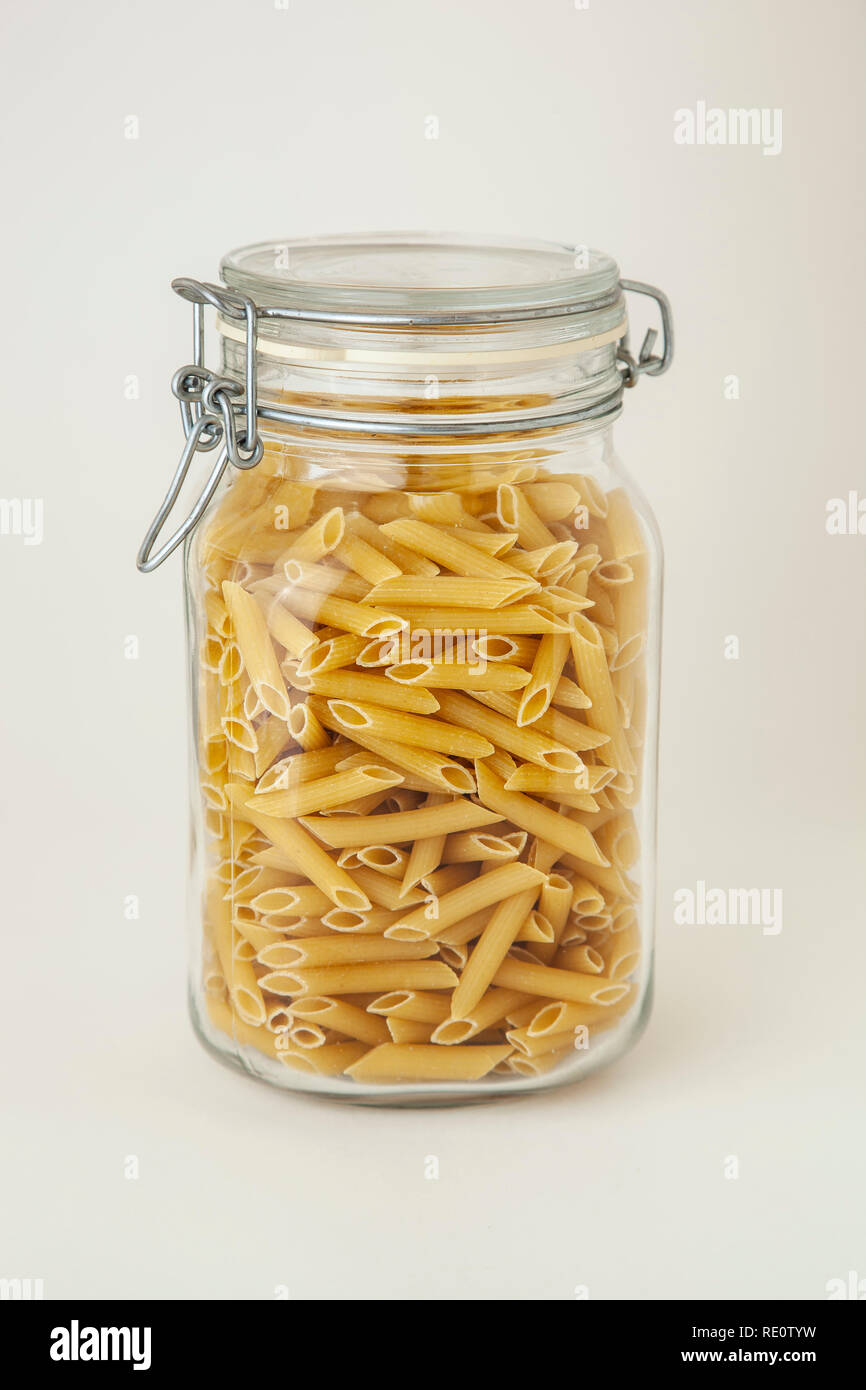 Dry penne pasta in glass jar Stock Photo - Alamy