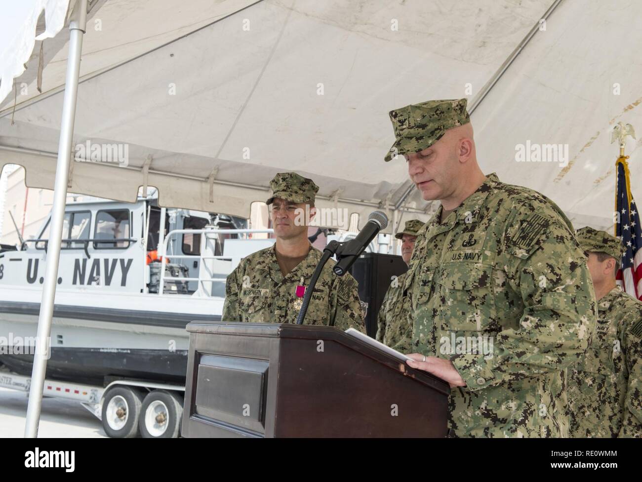 Capt. Bradley Andros, Commander, Task Force (CTF) 56, reads his orders ...