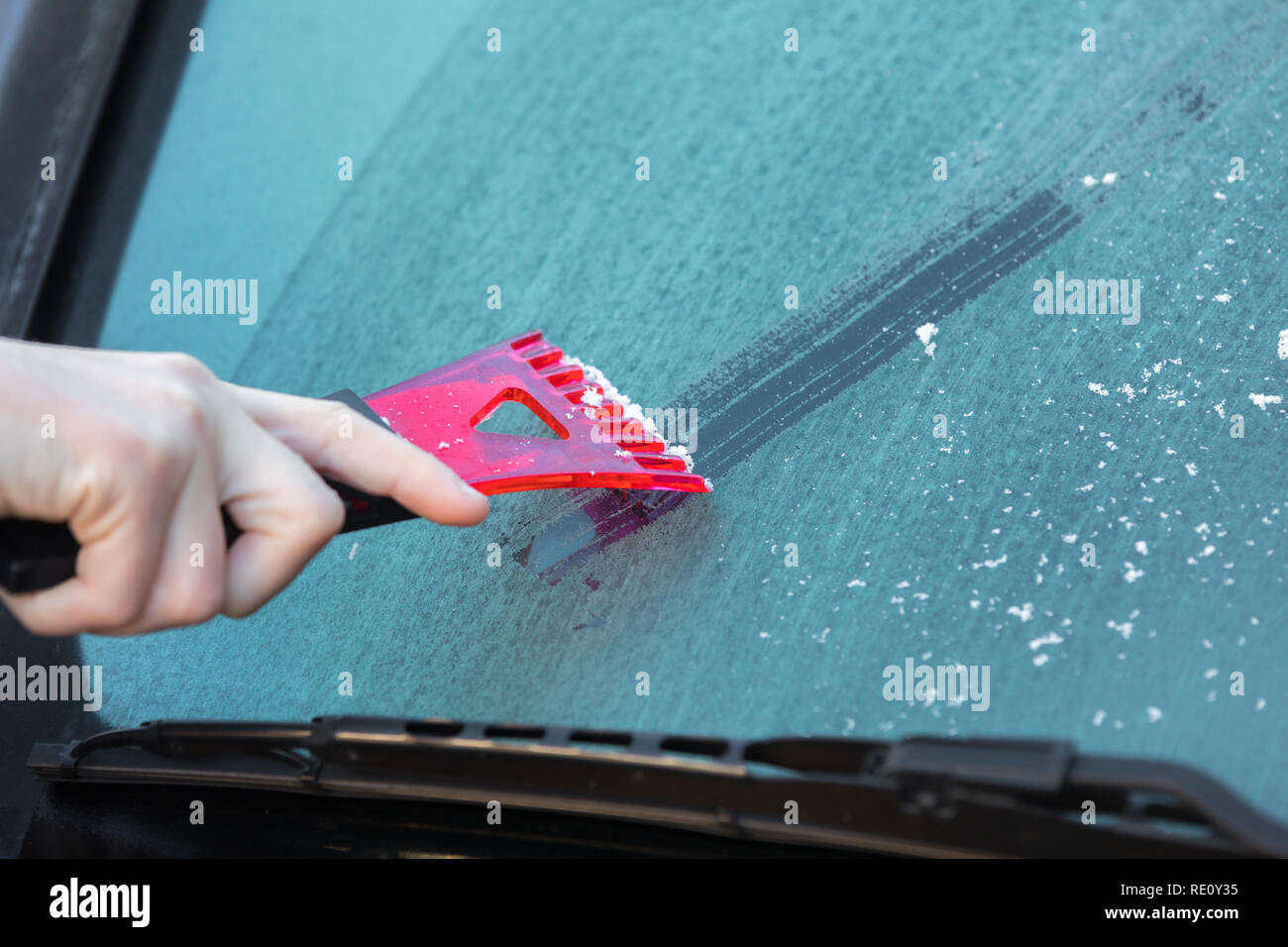 Winter scene, hand scraping ice from windshield of car Stock Photo - Alamy