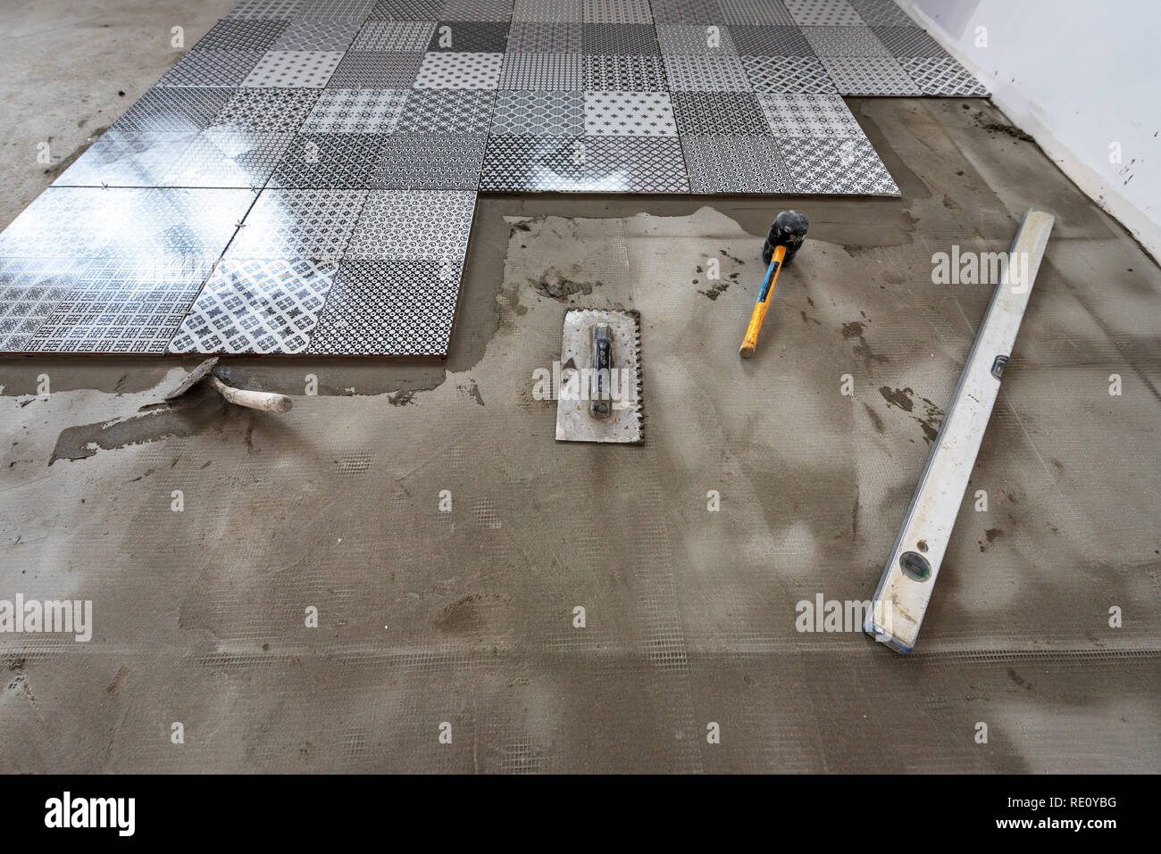 Ceramic tiles and tools for tiler. Floor tiles installation Stock Photo ...