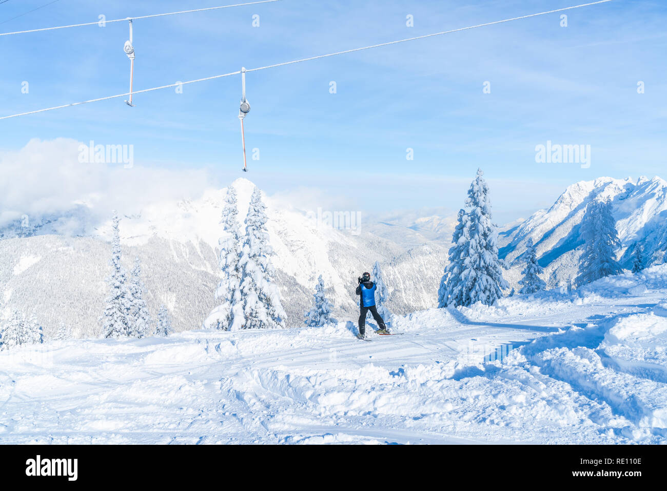 SEEFELD, AUSTRIA - JANUARY 11, 2019: Skier on a ski slope takes a photo ...