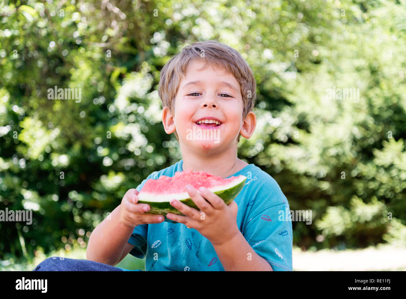 healthy eating concept, boy eating watermelon outdoors, vitamins and ...