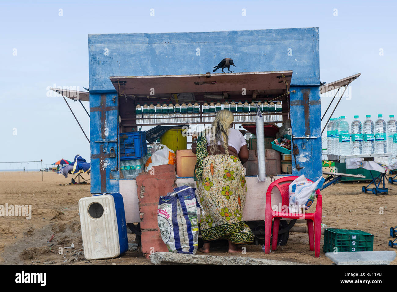 A lady stands outside a makeshift food stall on Marina Beach, Chennai ...