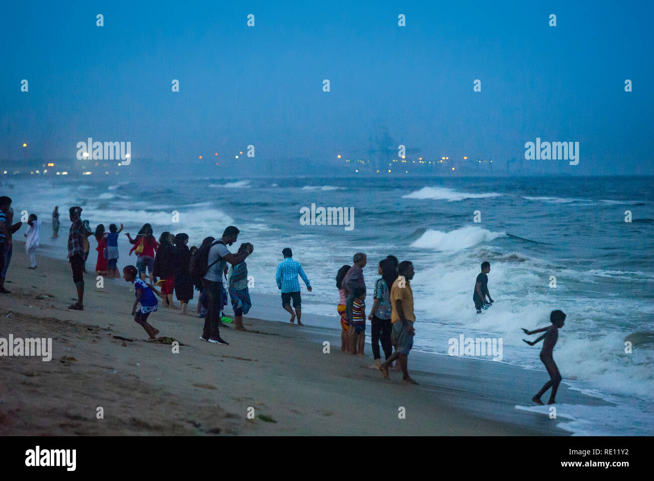 Crowds of people enjoy the last of the light on Marina Beach in Chennai ...