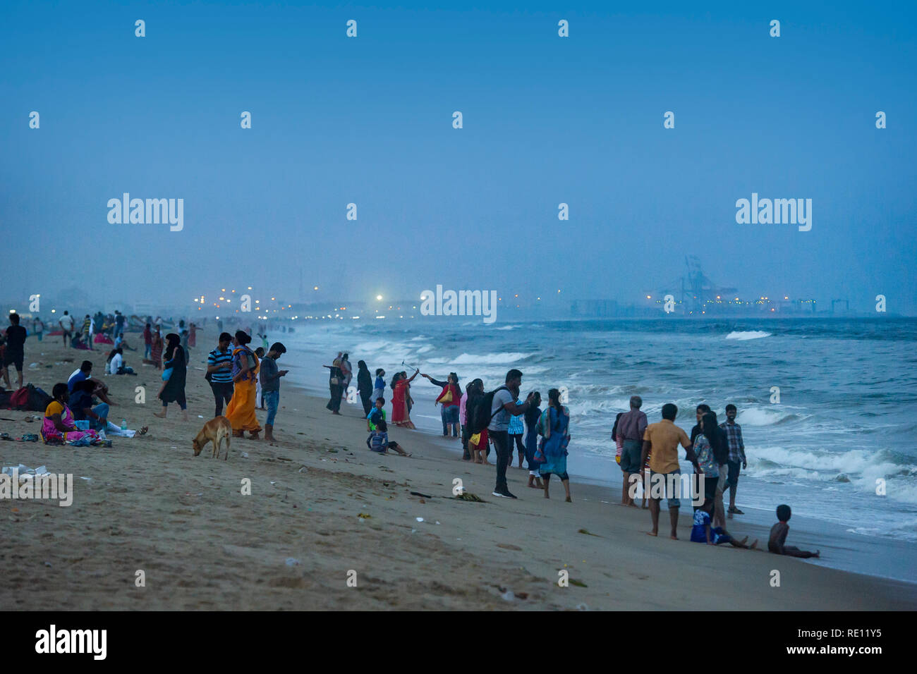 Crowds of people enjoy the last of the light on Marina Beach in Chennai ...