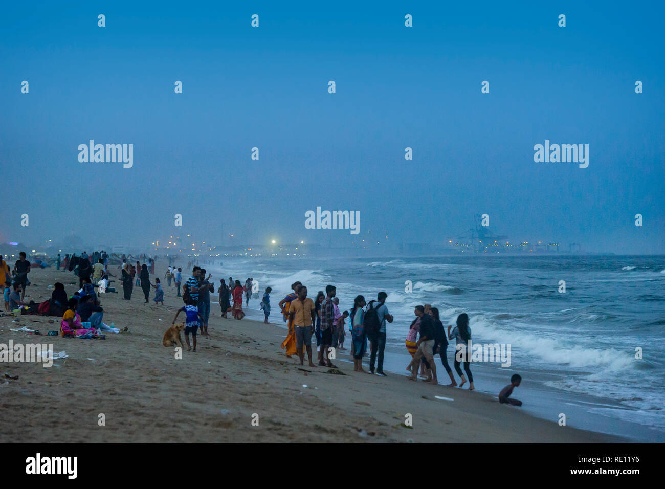 Crowds of people enjoy the last of the light on Marina Beach in Chennai ...