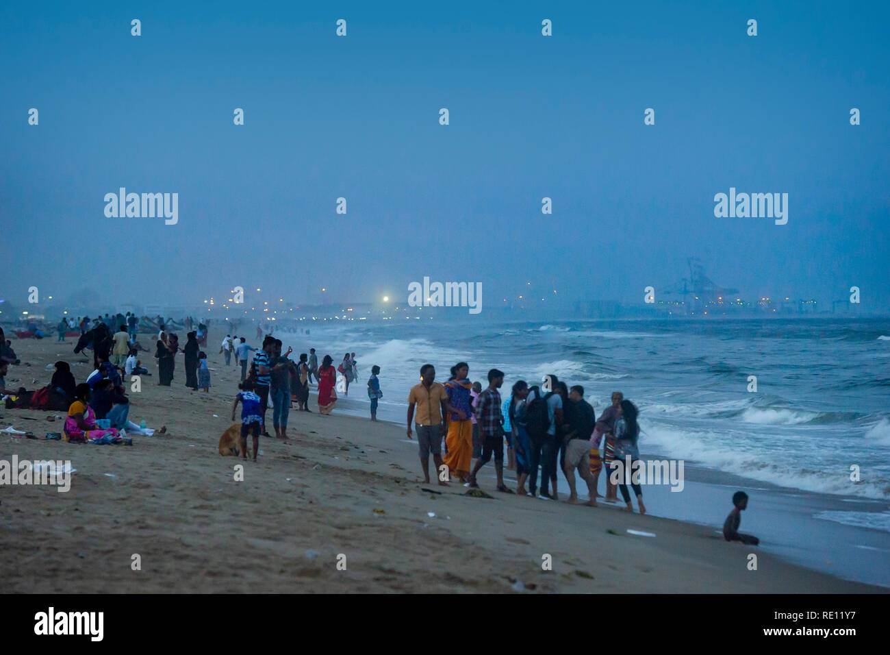 Crowds of people enjoy the last of the light on Marina Beach in Chennai ...