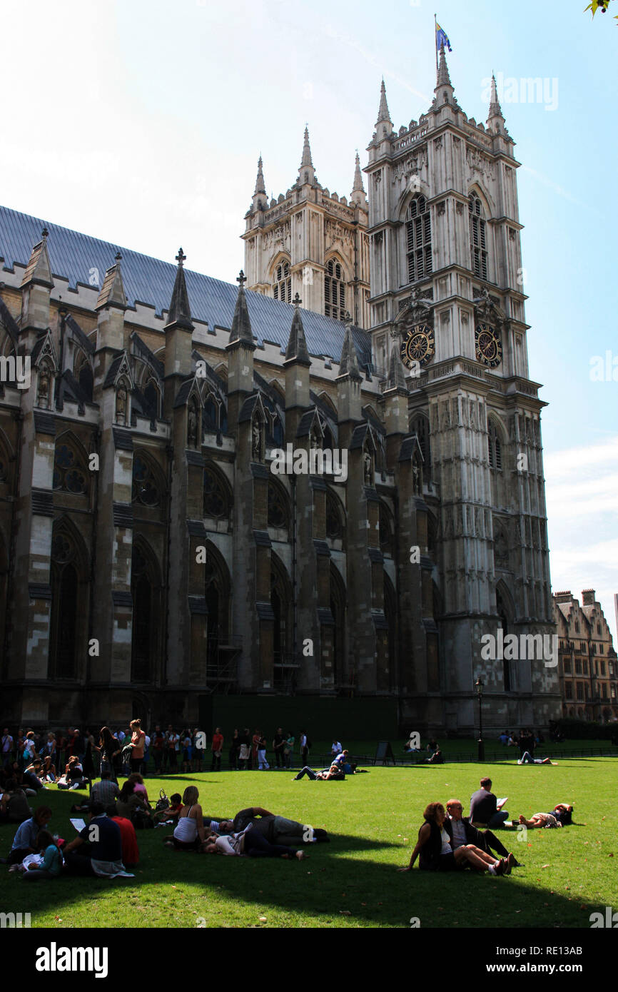 People sitting on the lawn in front of the Collegiate Church of St ...