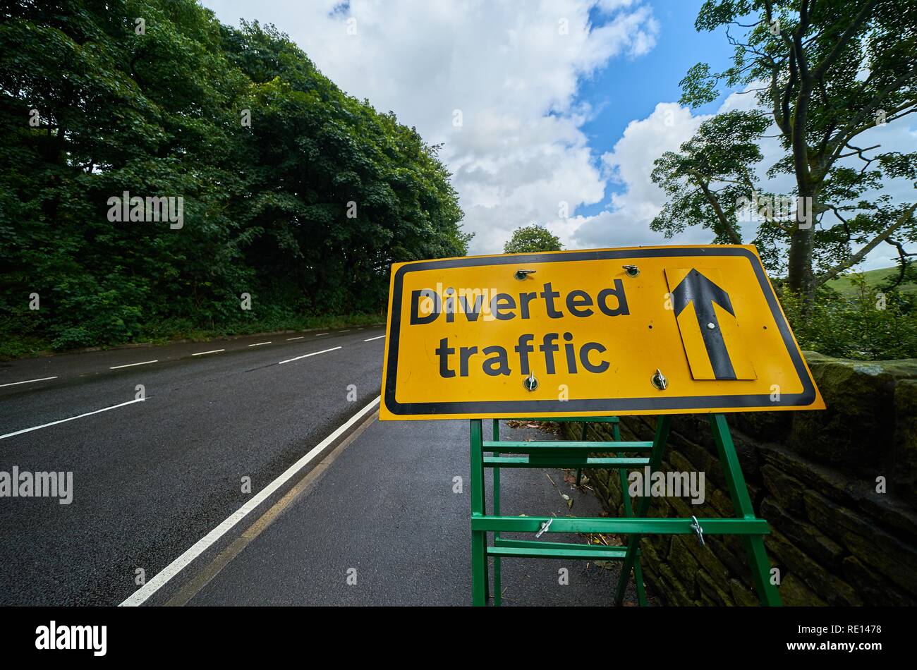 Yellow traffic diversion sign on country road. Sign reads 'Diverted ... Yellow traffic diversion sign on country road. Sign reads 'Diverted ...