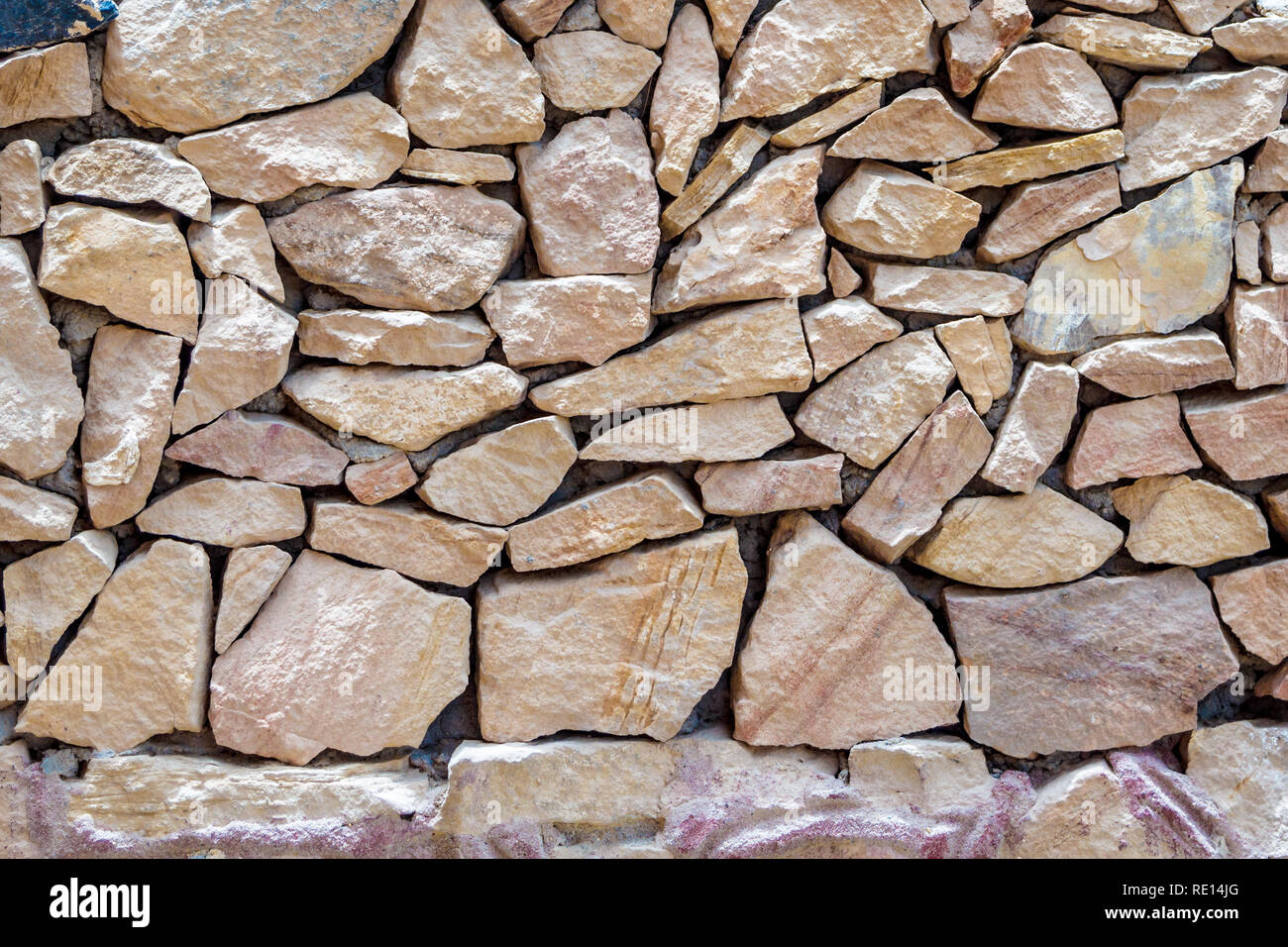 Fragment of a wall from a colour chipped stone background texture photo ...