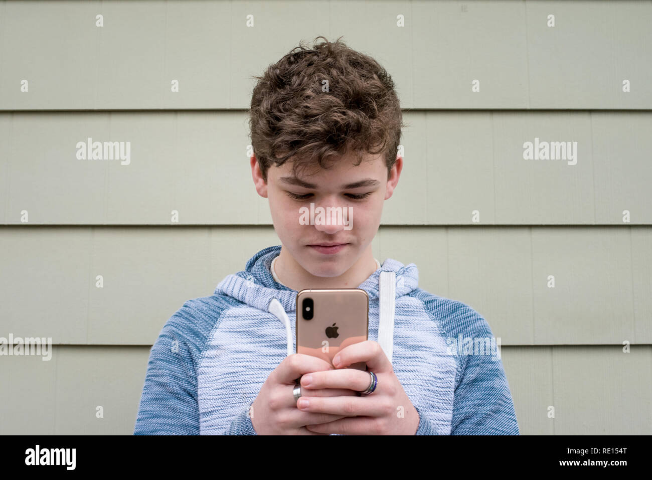 Teenage boy texting on his new Apple iPhone X Stock Photo - Alamy