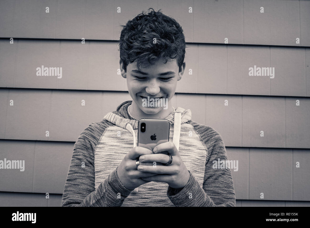 Teenage boy texting on his new Apple iPhone X, smiling Stock Photo - Alamy