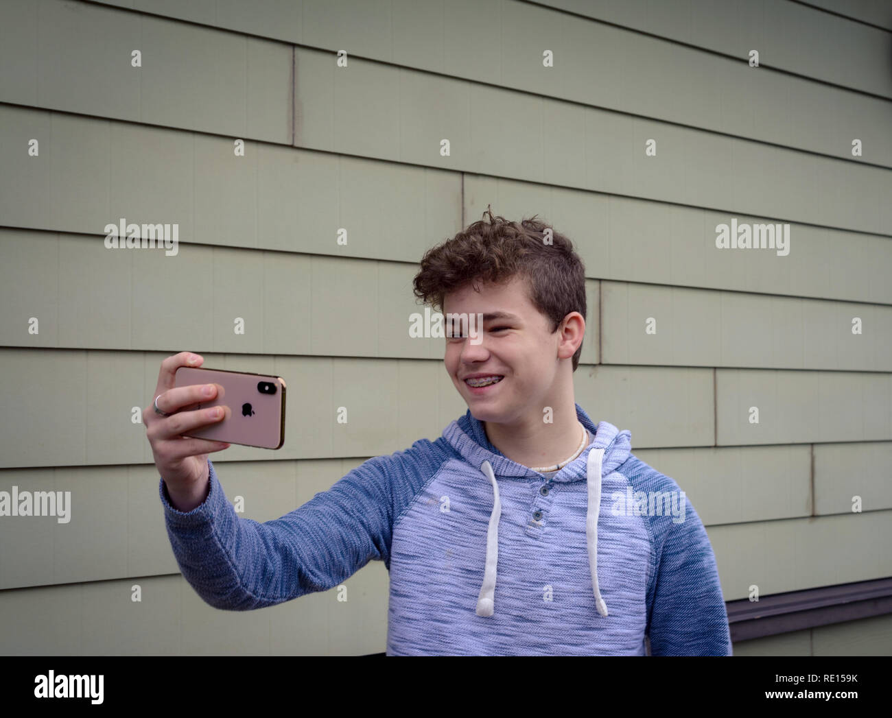 Boy holding iphone hi-res stock photography and images - Alamy
