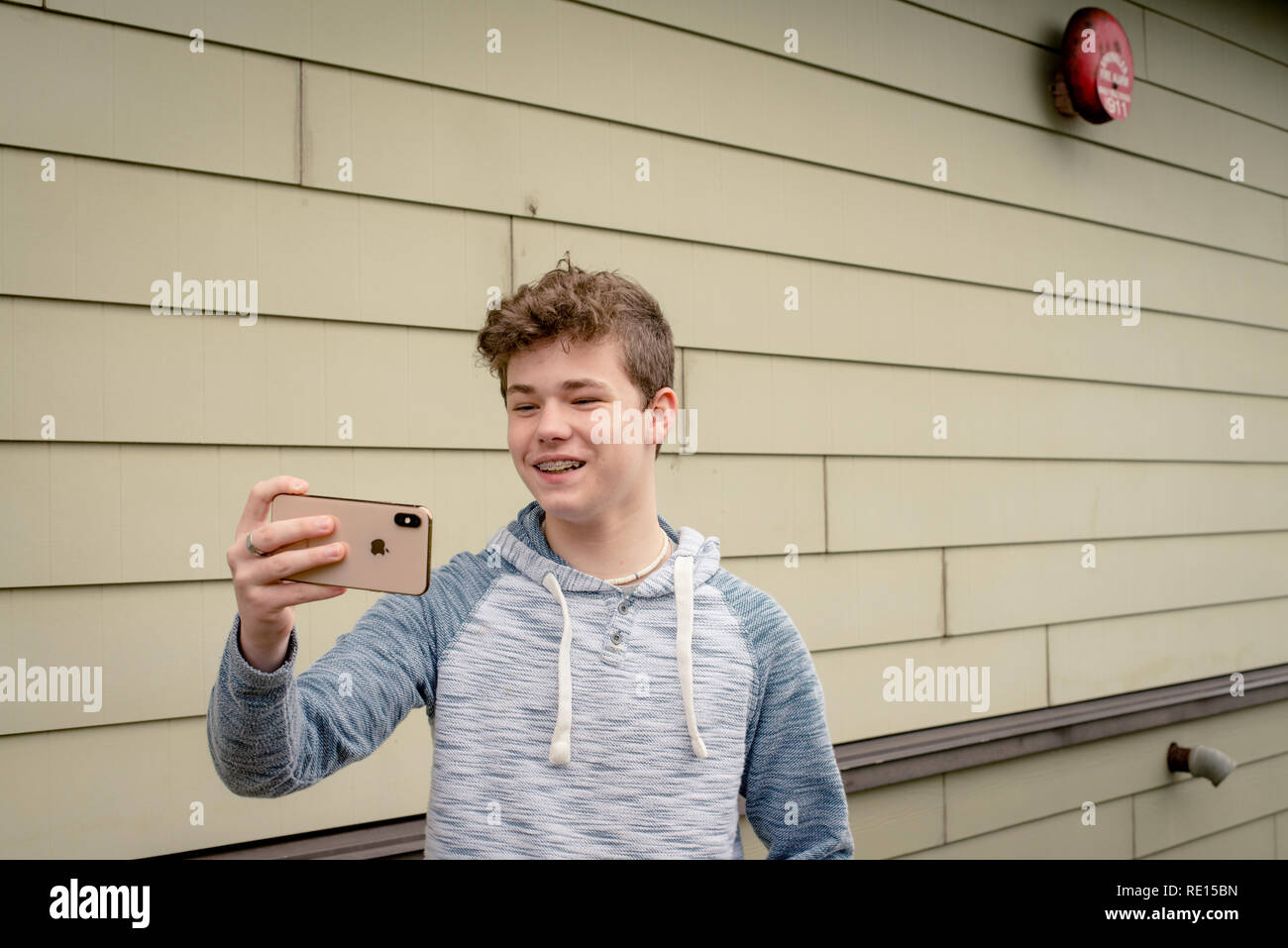Boy holding iphone hi-res stock photography and images - Alamy