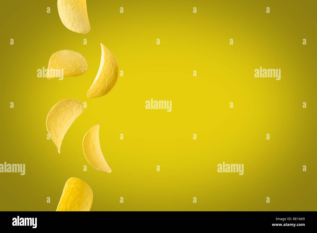 Falling potato chips isolated on yellow background. Flying crispy ...