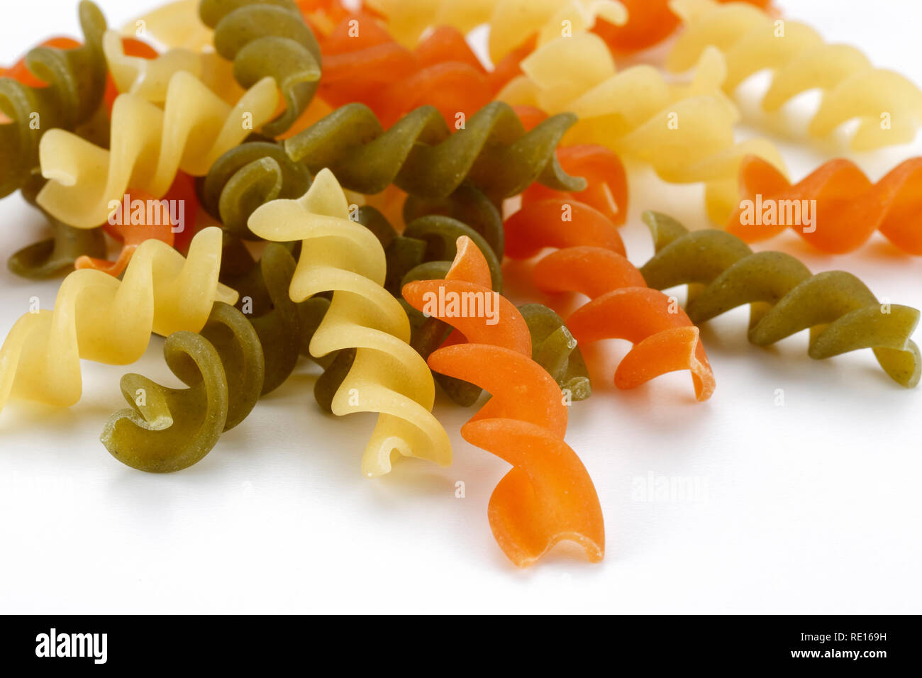 Mixed color fusilli pasta isolated on white background Stock Photo - Alamy