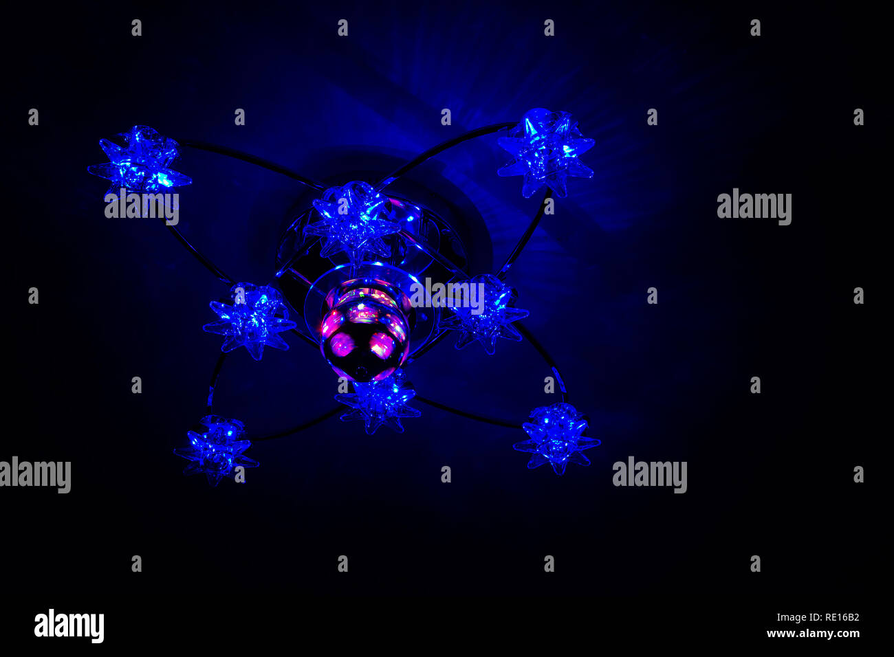 Glowing soft blue light glass chandelier unusual shape Stock Photo - Alamy