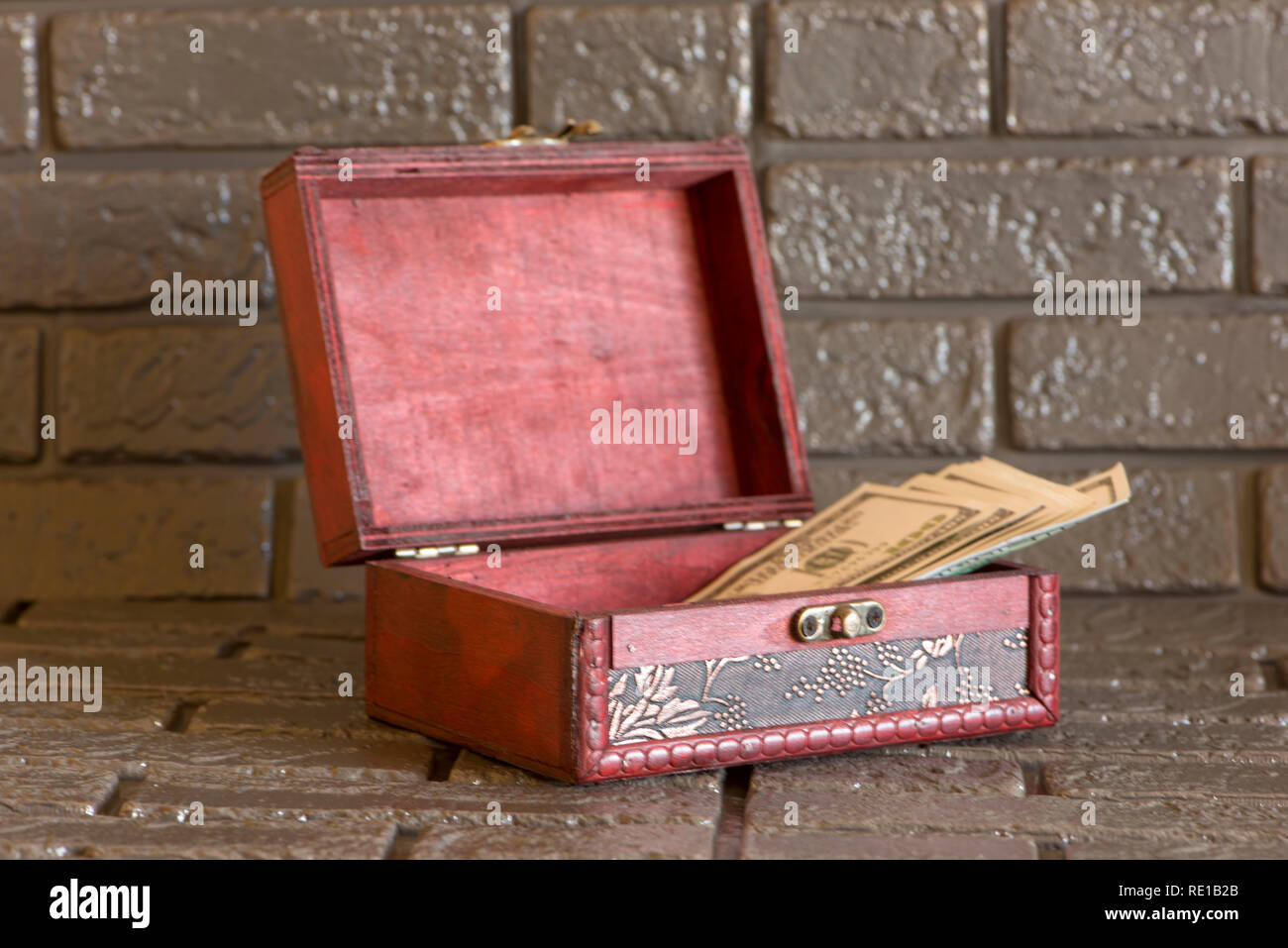 Several dollar bills inside an old brown box Stock Photo - Alamy