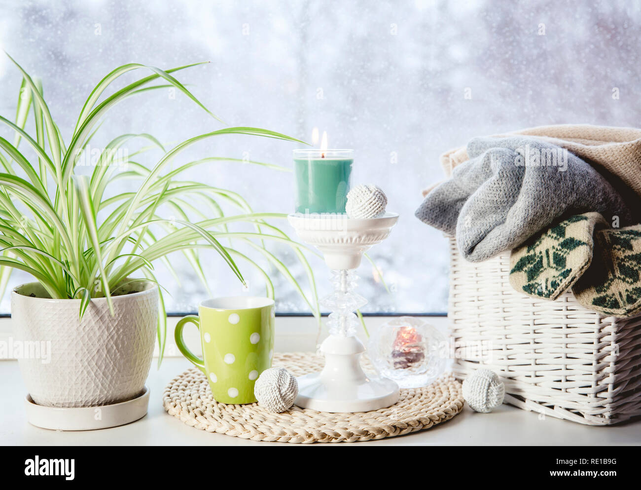 Cozy winter set on window sill. Romantic style tall candle holder ...