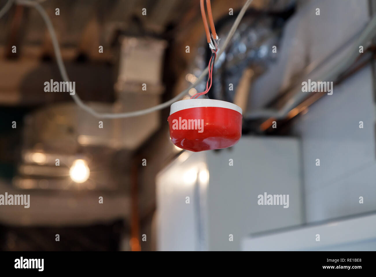 Closeup installation and repair of electric cable, smoke detector, fire ...