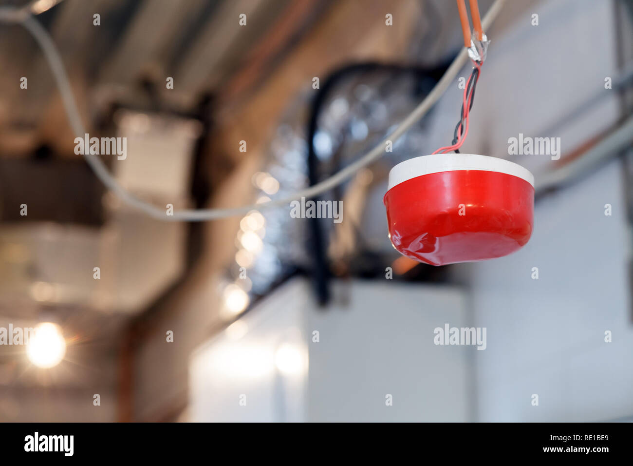 Closeup installation and repair of electric cable, smoke detector, fire ...