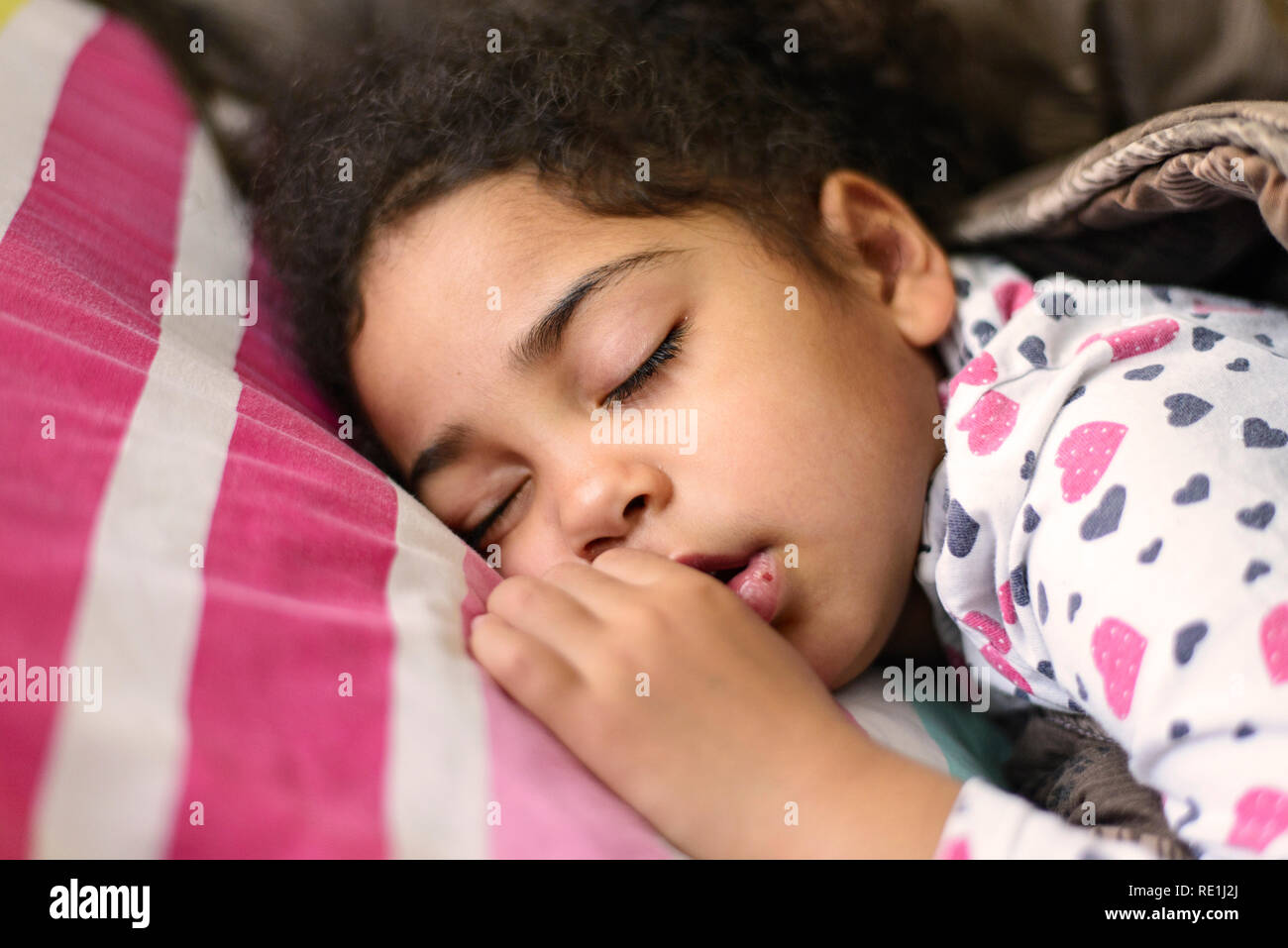 Little African American girl sleeping in bed, child taking a nap during ...