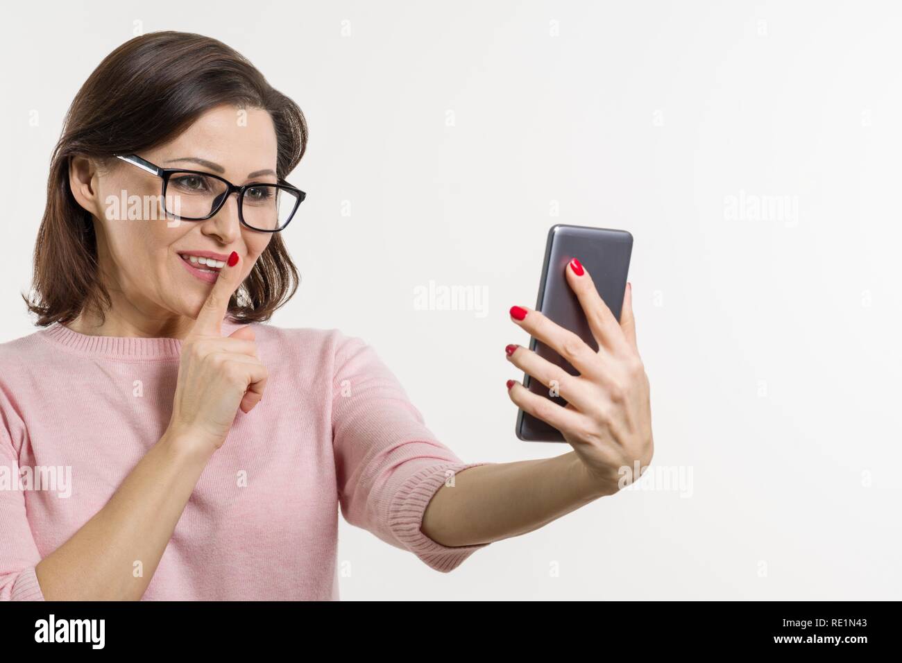 Portrait of a woman tells secrets and gossip on the cell phone ...