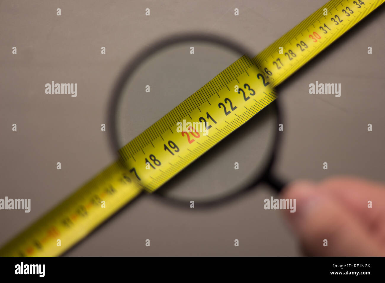 measurement tool through magnifying glass on grey background Stock ...