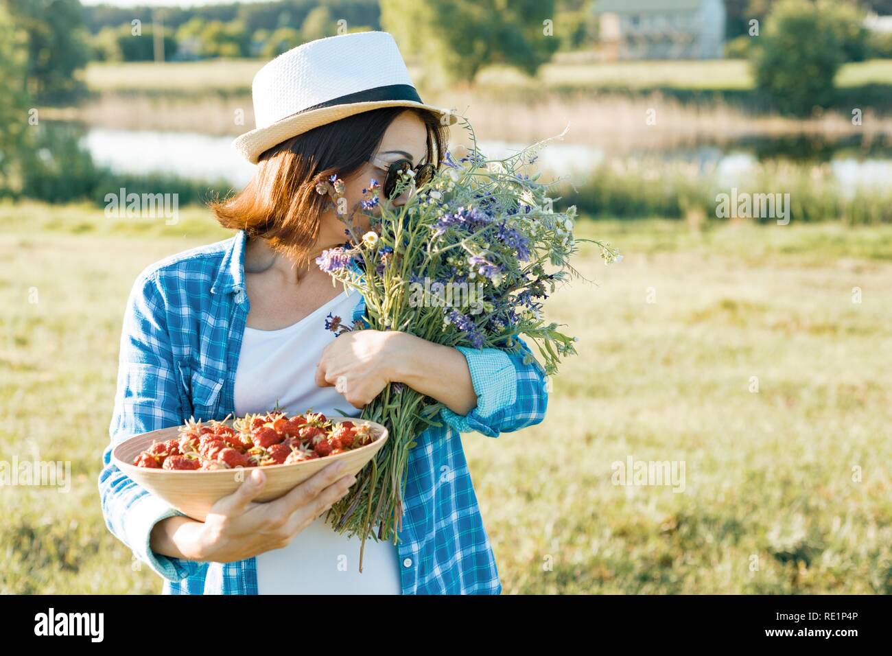 Outdoor Summer Portrait Of Adult Woman With Strawberries Bouquet Of