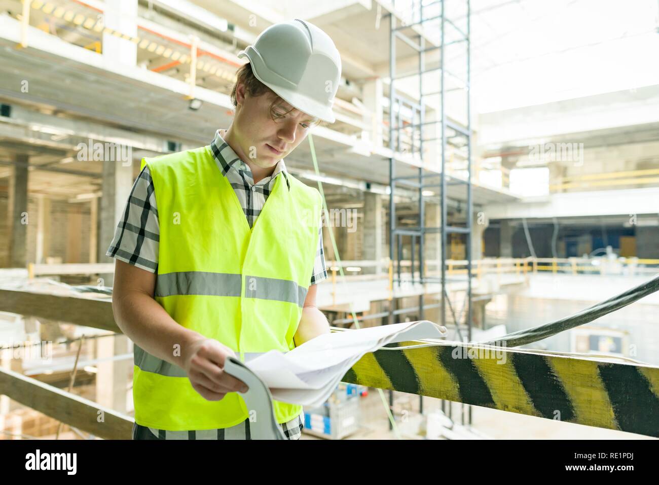 Young male architect at a construction site. Building, development ...