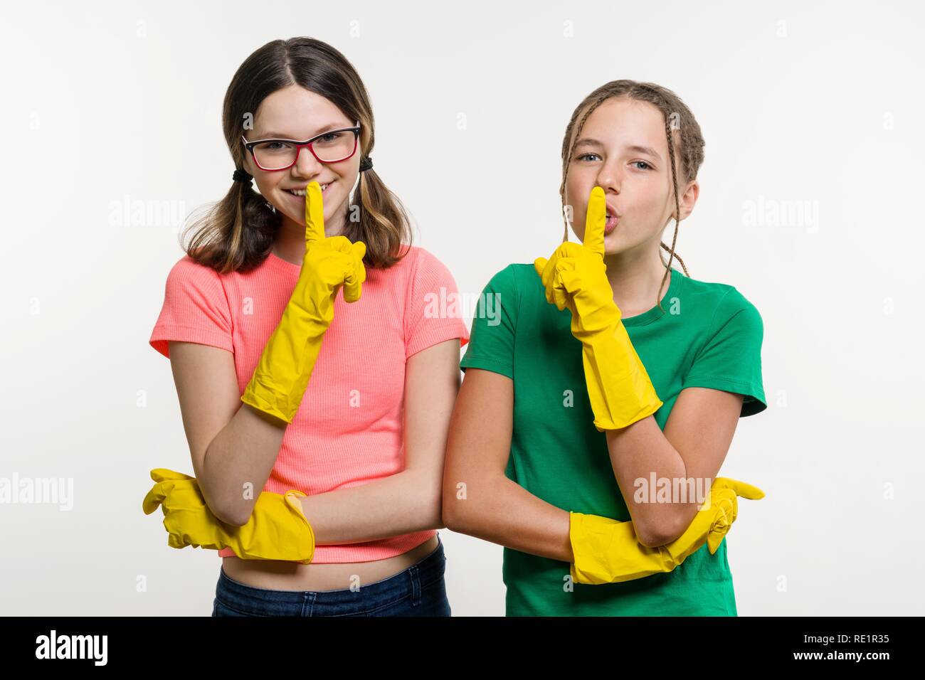 Cleaning, domestic duties and teamwork concept. Two teenage sisters ...