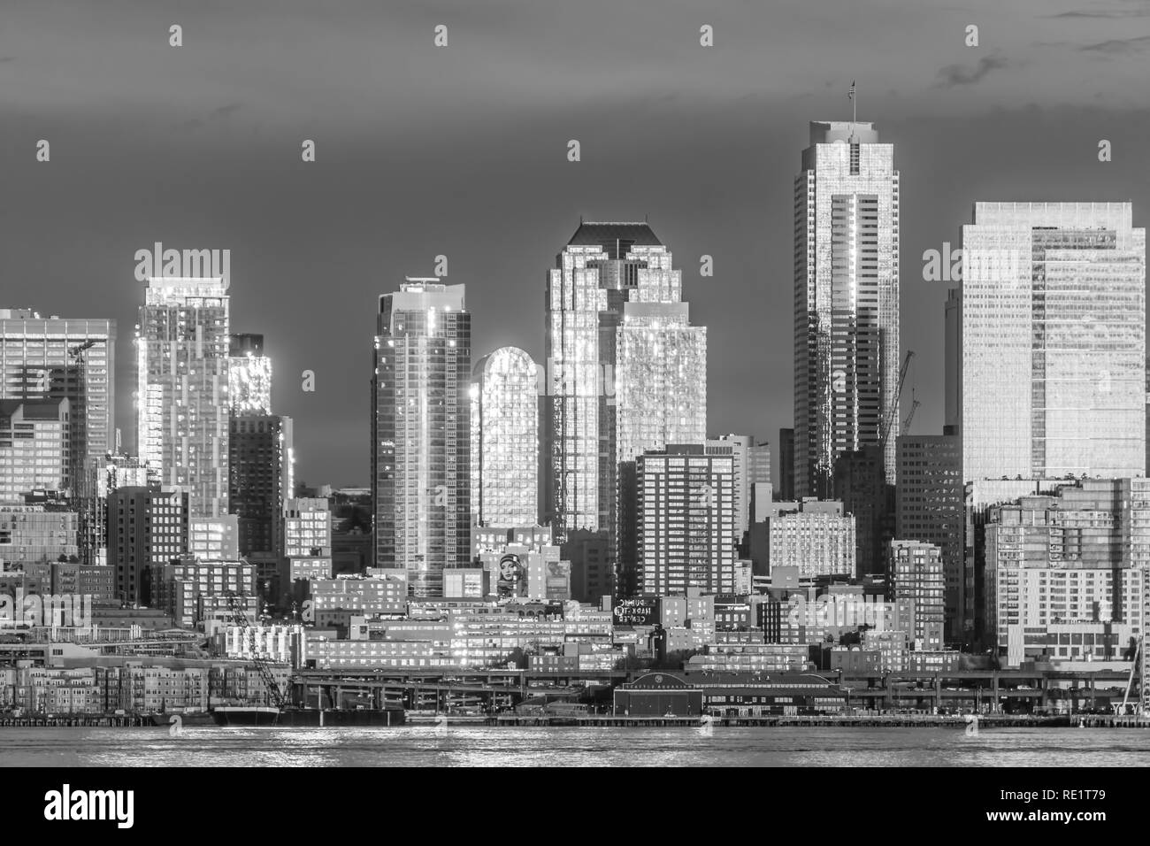 The setting sun is reflected from the skyscrapers in the Seattle ...