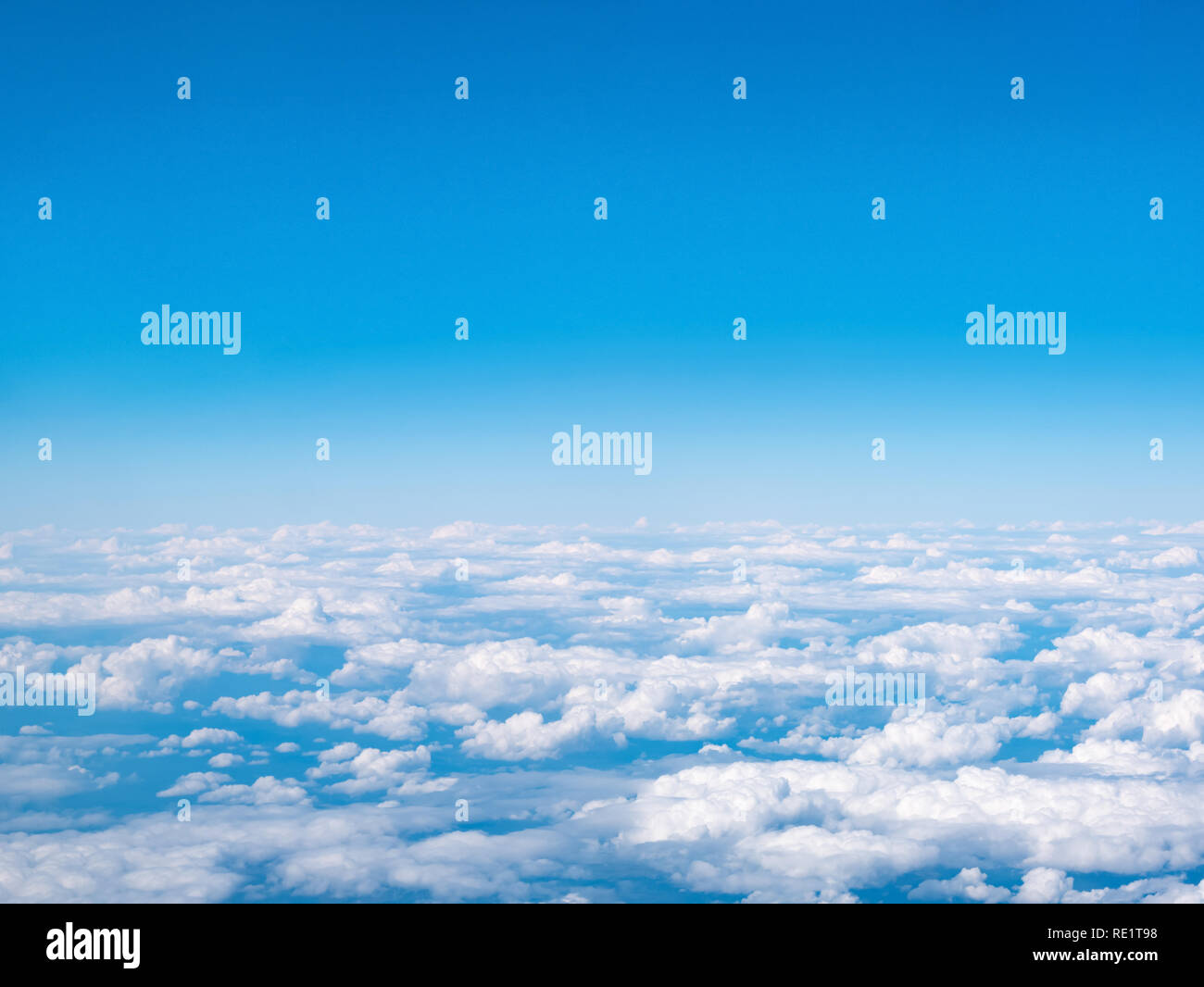 Aerial view of blue sky and white Clouds. Top view from airplane window ...