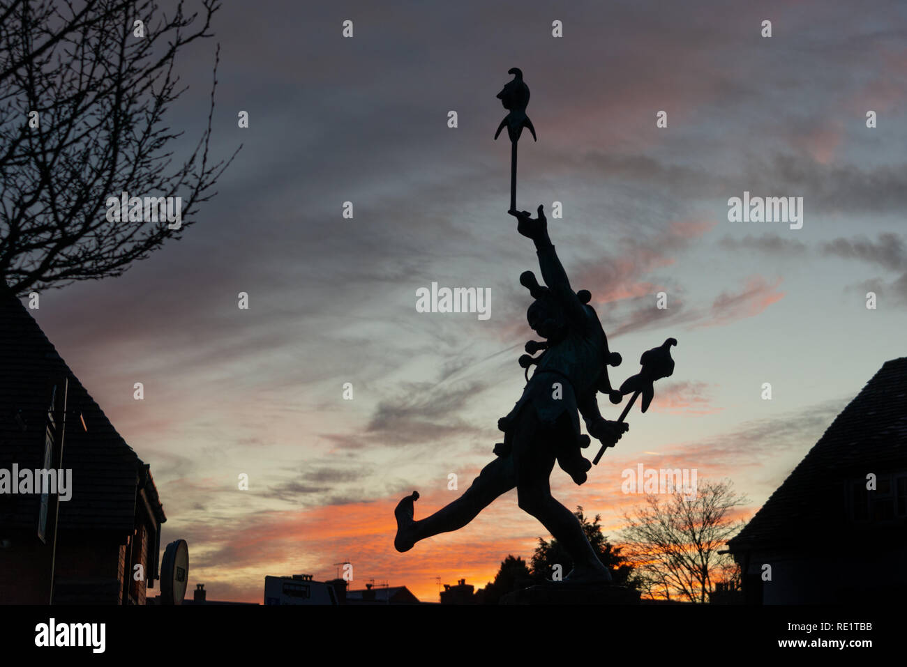 silhouette of court jester or imp toy dancing over rooftops Stock Photo ...