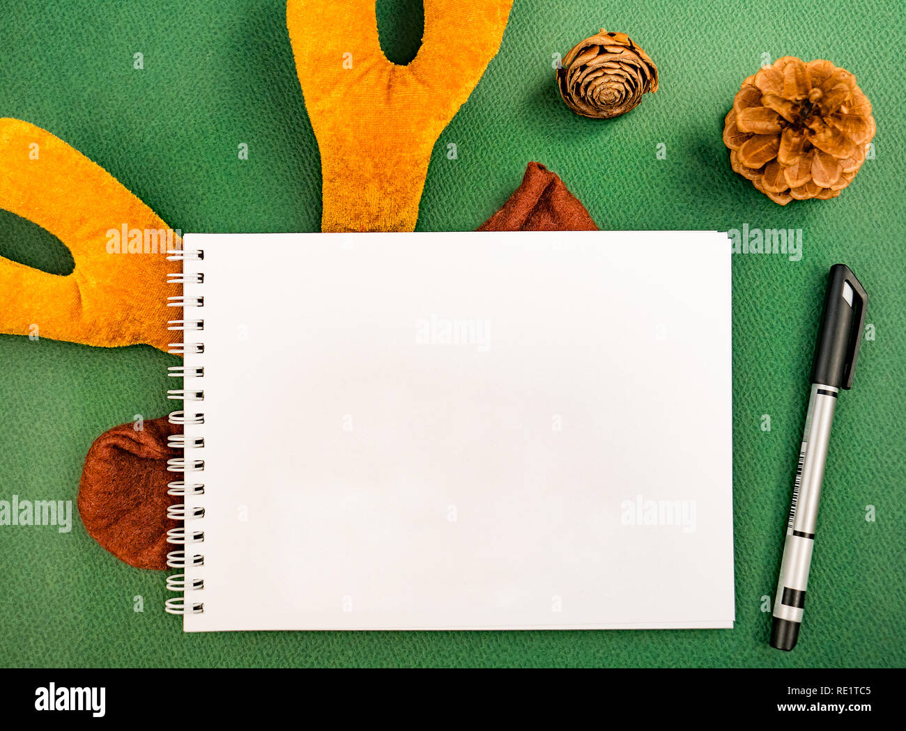 Top view of Christmas background with blank open notepad, pen and ...
