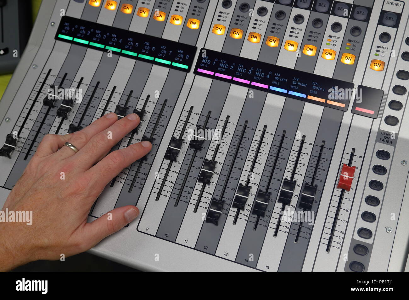 Hand mixing audio on Digital Sound mixing console Stock Photo - Alamy