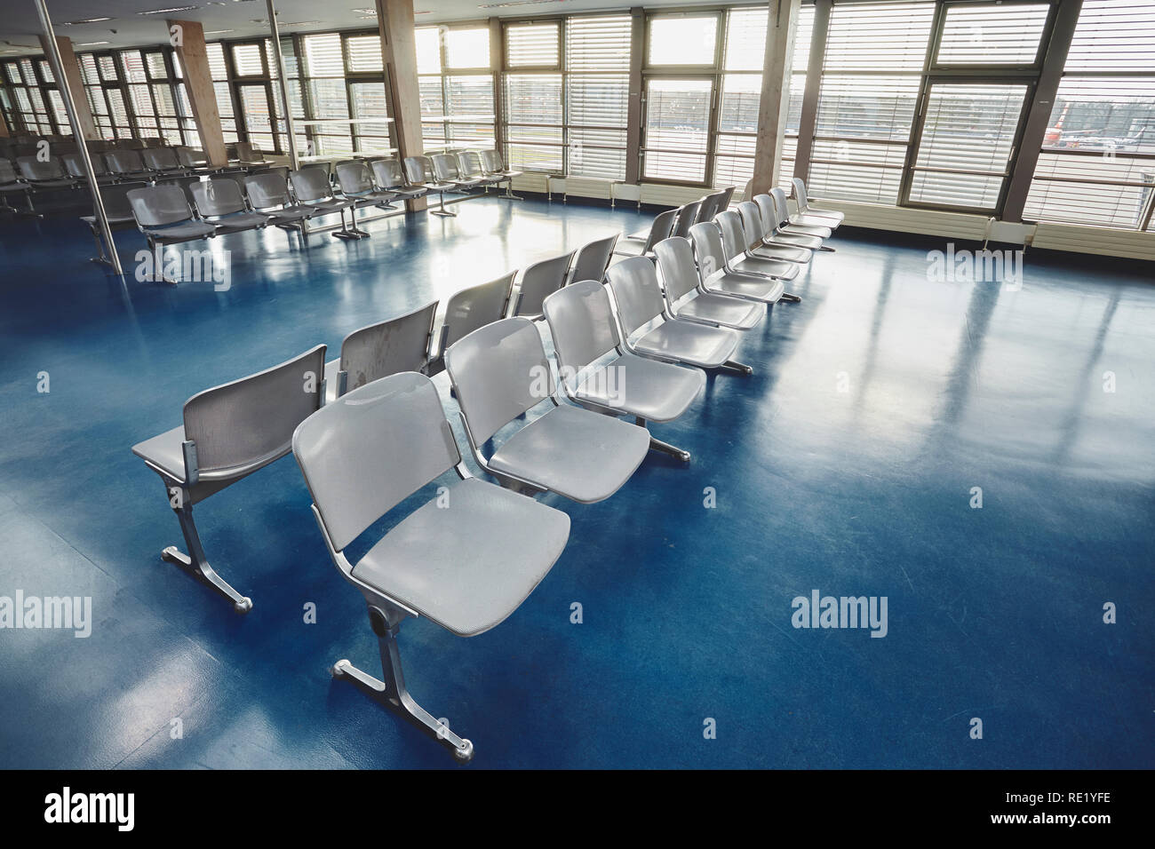 Airport empty waiting room with a blue floor Stock Photo - Alamy