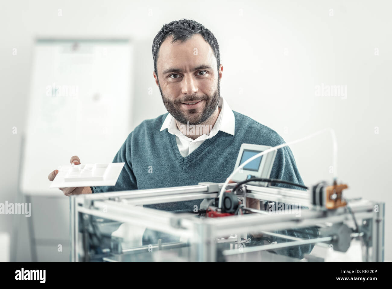Positive smart adult man using 3d printer Stock Photo - Alamy