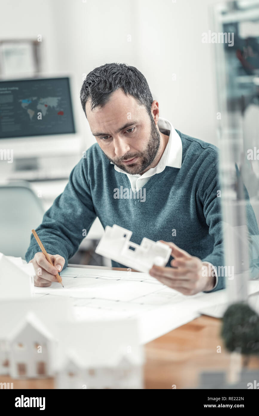 Serious skilled adult engineer doing a blueprint Stock Photo - Alamy