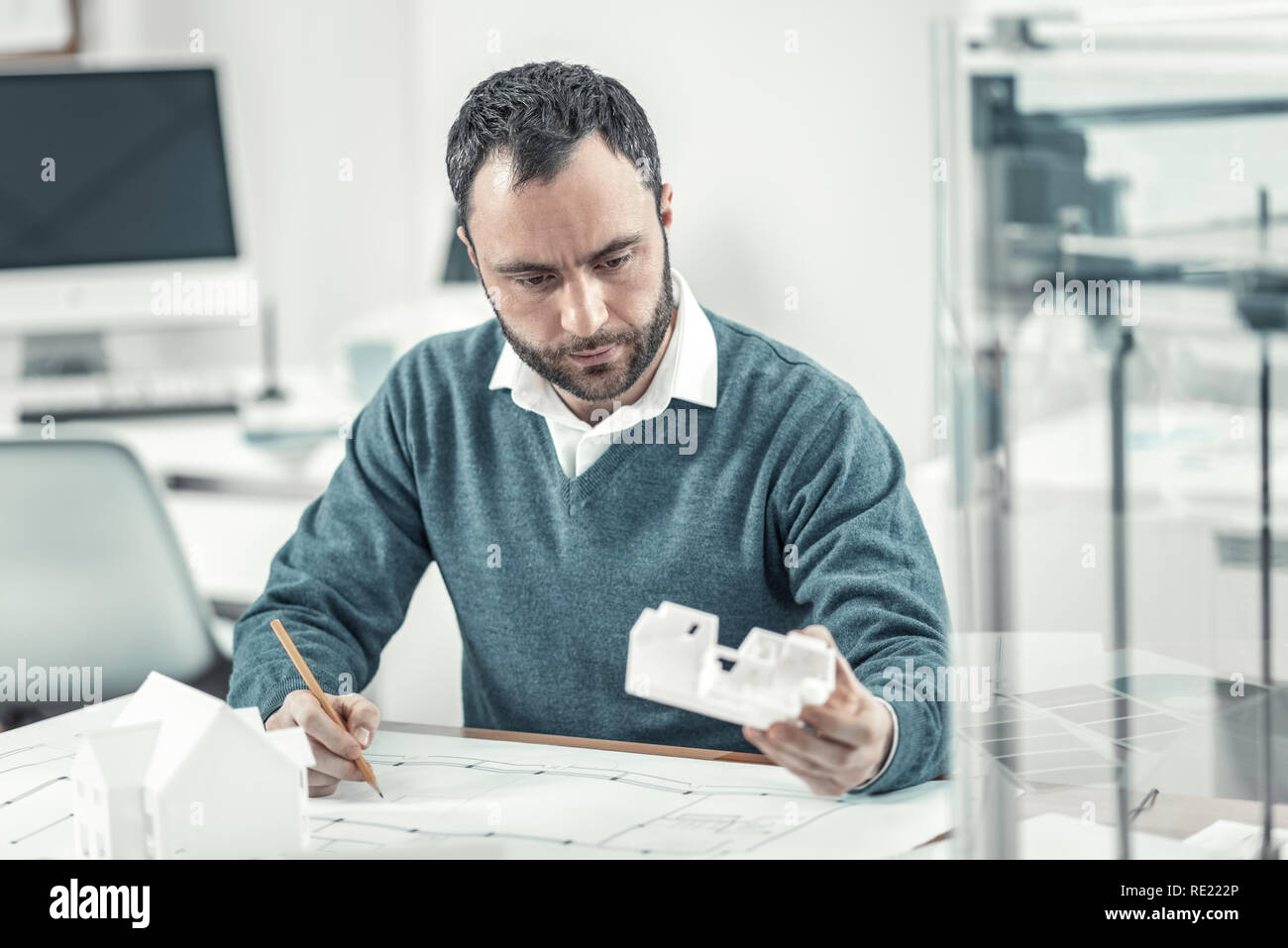Smart nice adult man drawing a detail Stock Photo - Alamy