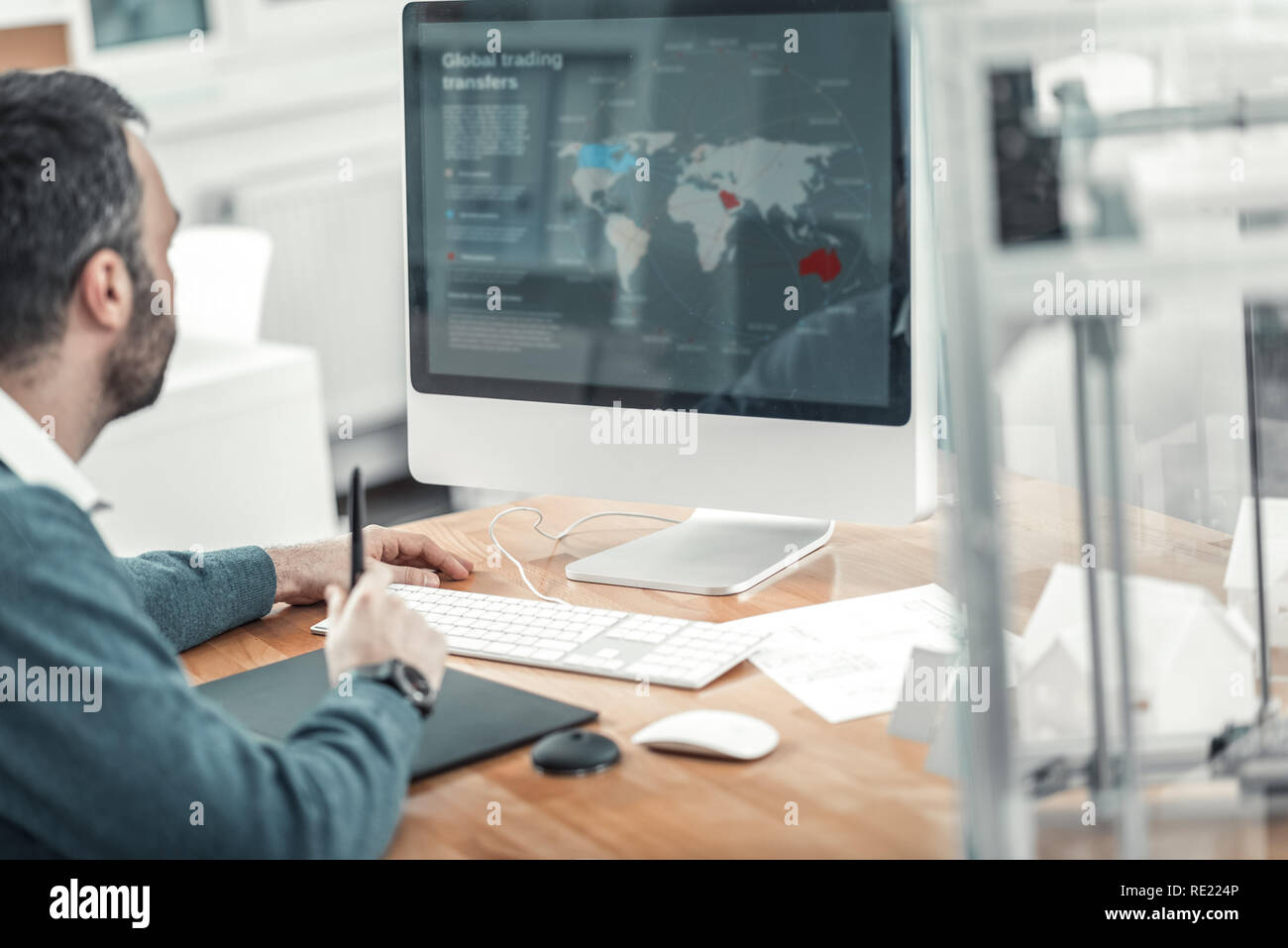 Serious nice man looking at the computer screen Stock Photo - Alamy
