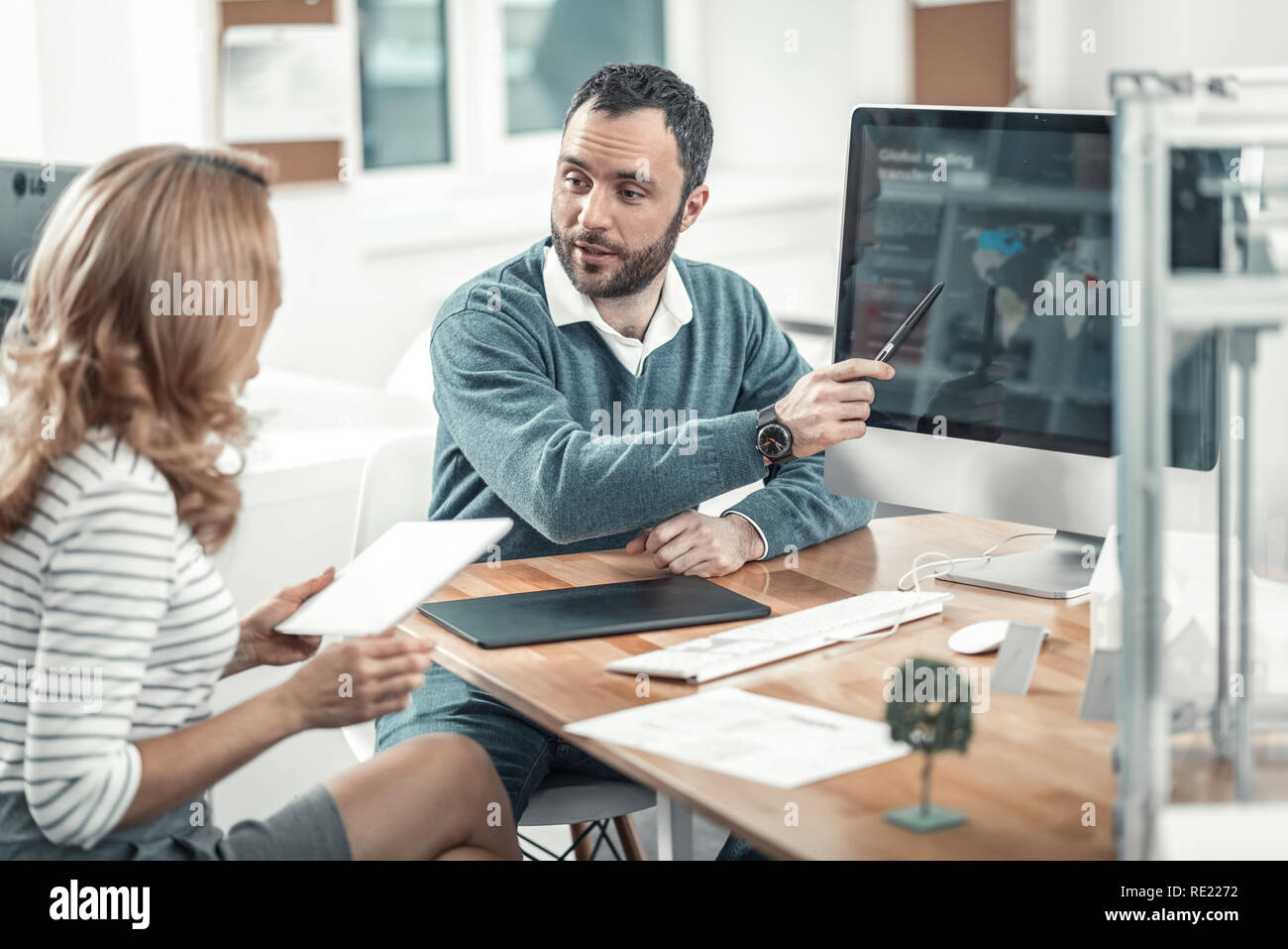 Smart nice man pointing at the computer screen Stock Photo - Alamy
