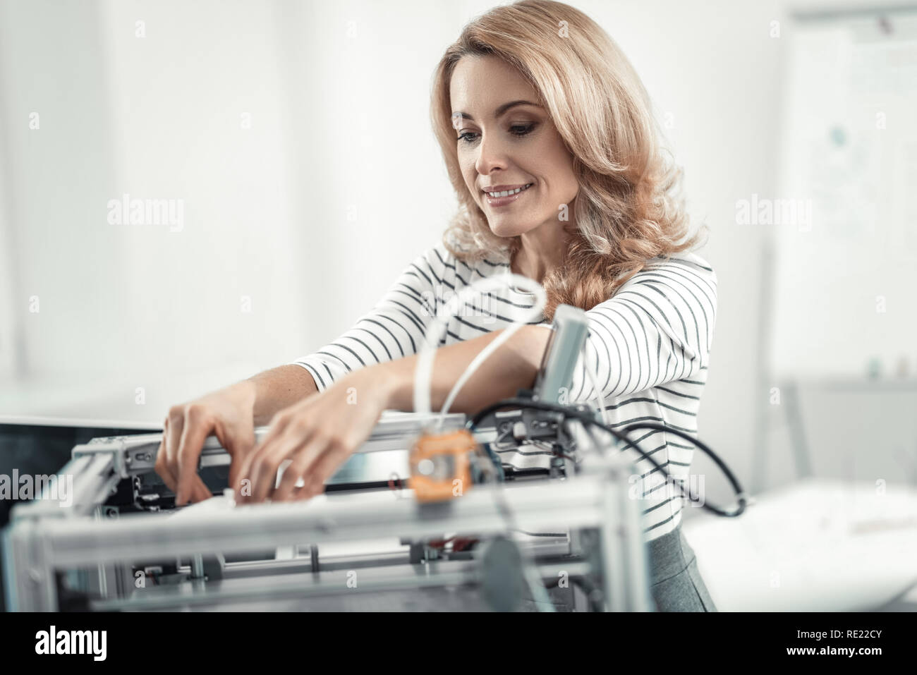 Joyful positive woman using a 3d printer Stock Photo - Alamy