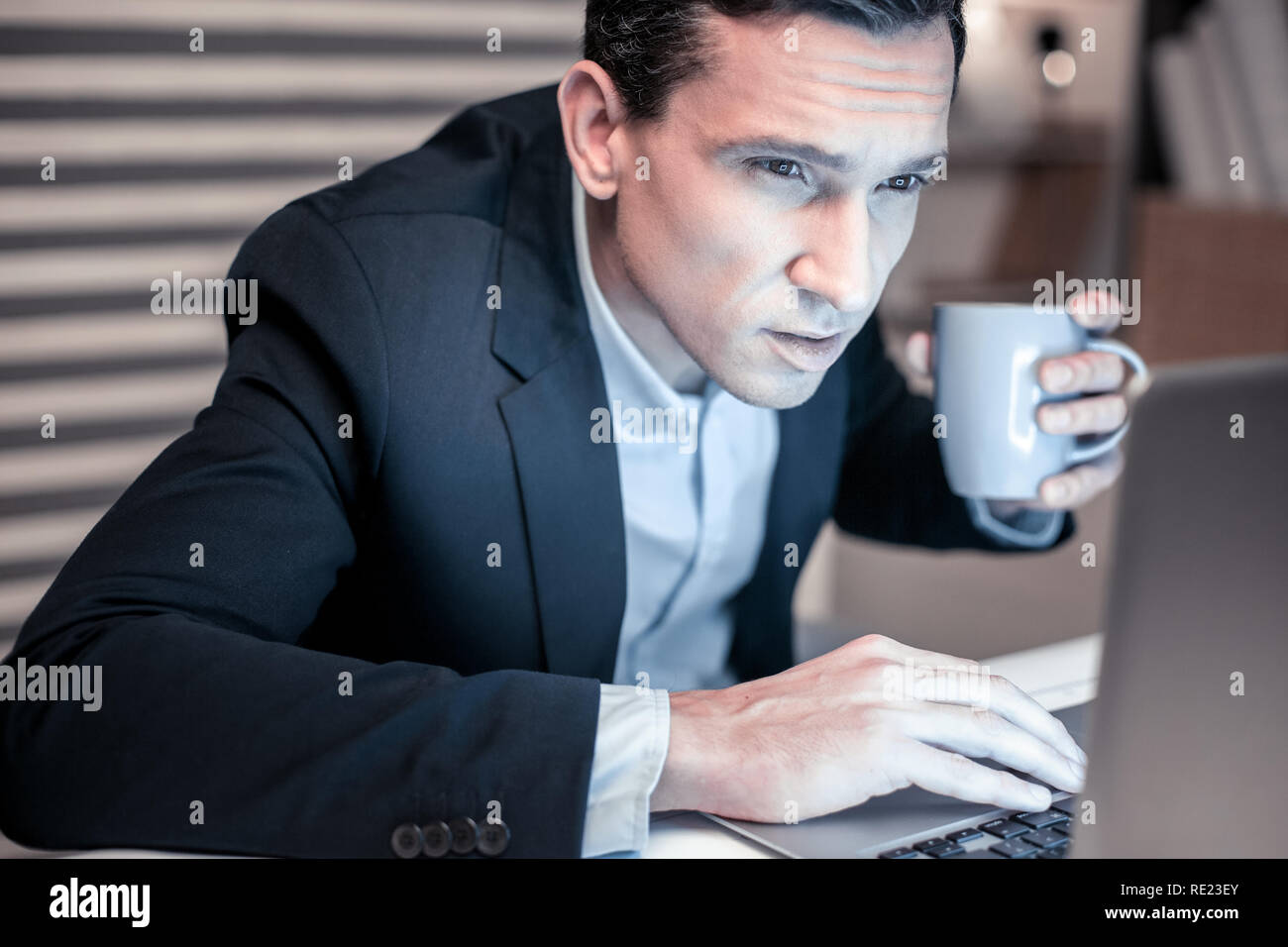 Nice handsome man focusing on his work Stock Photo - Alamy