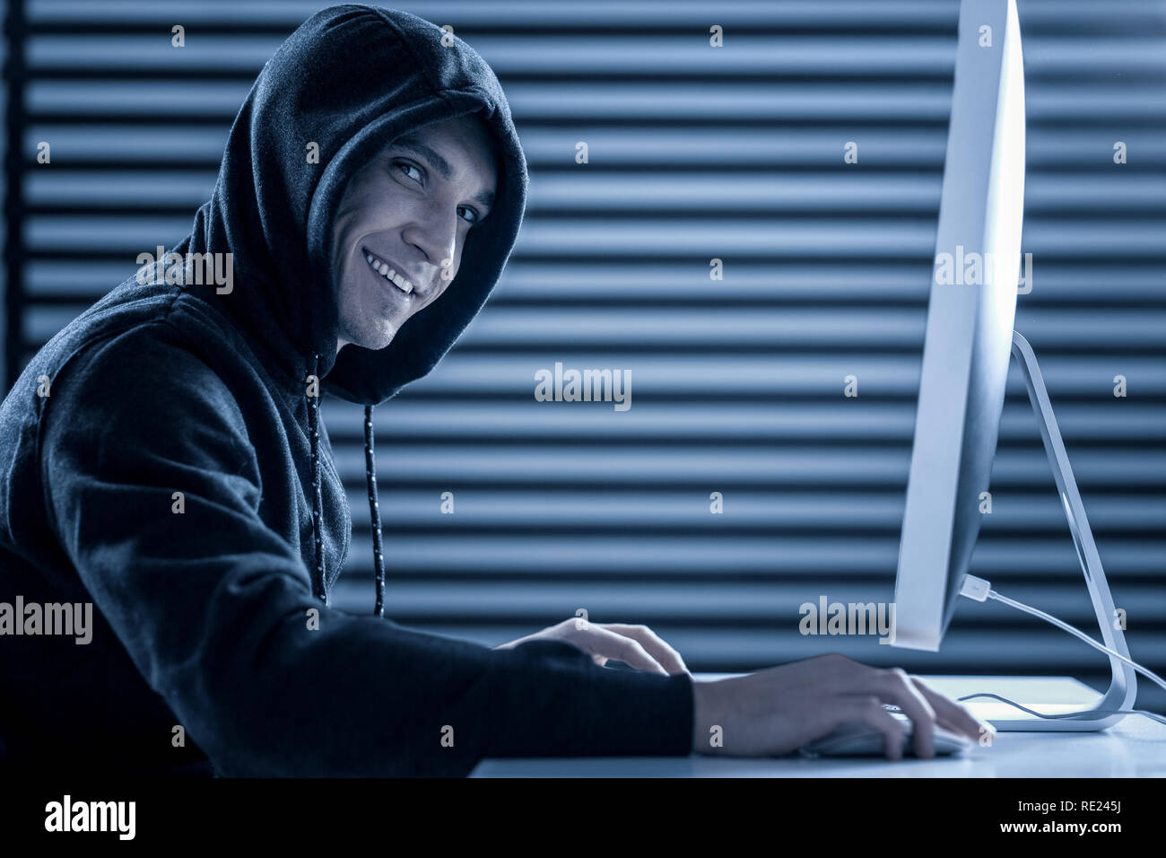 Joyful positive professional hacker smiling to you Stock Photo - Alamy