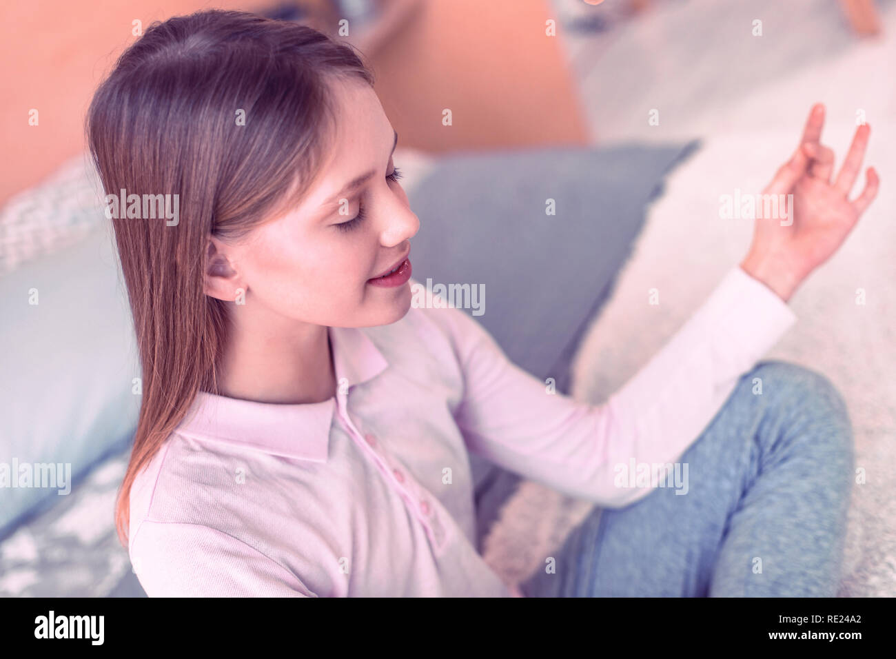 Young smiling girl sitting on the bad Stock Photo - Alamy
