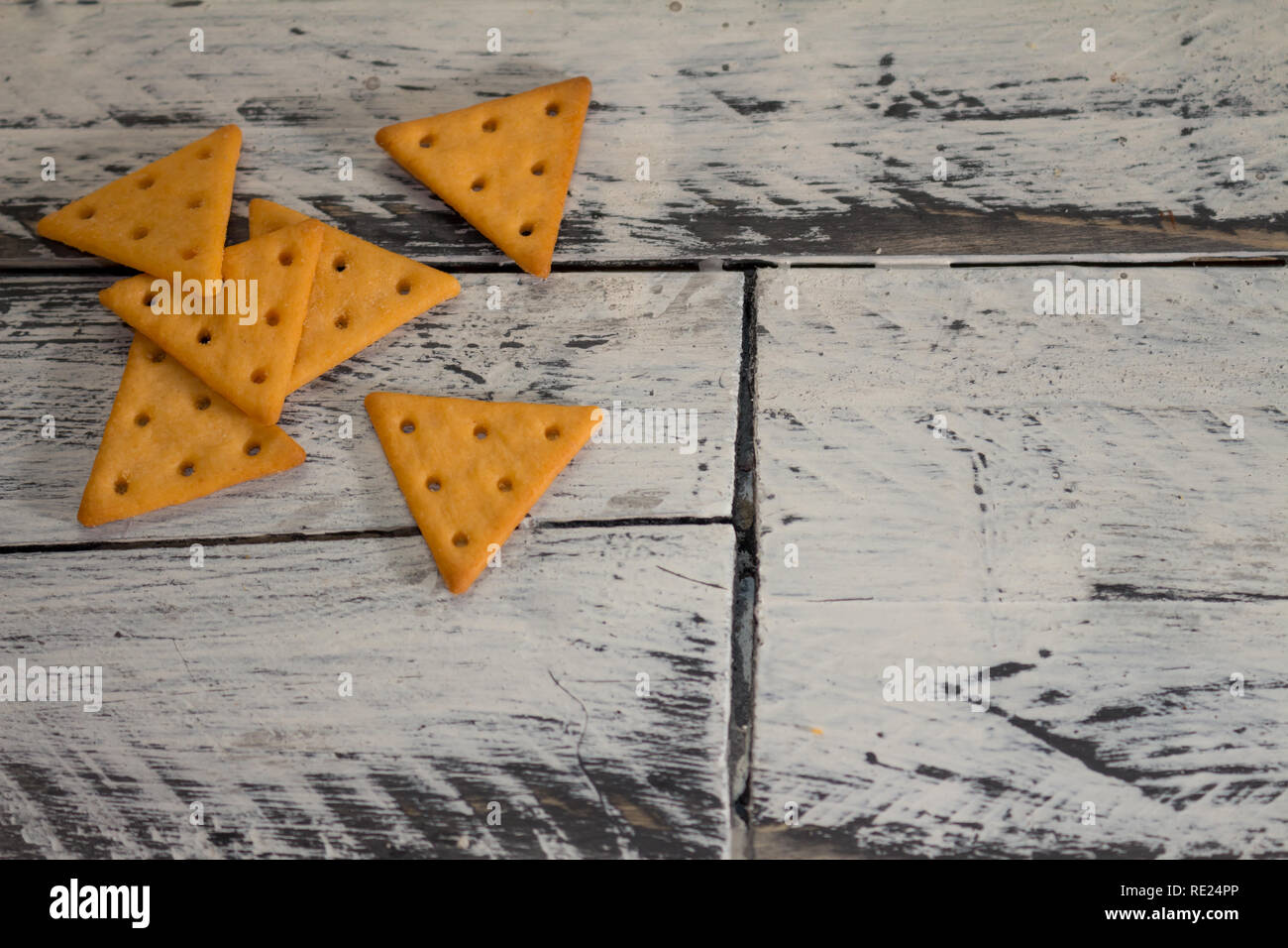 Salty cookies in a triangular shape on a white and black rustic board ...