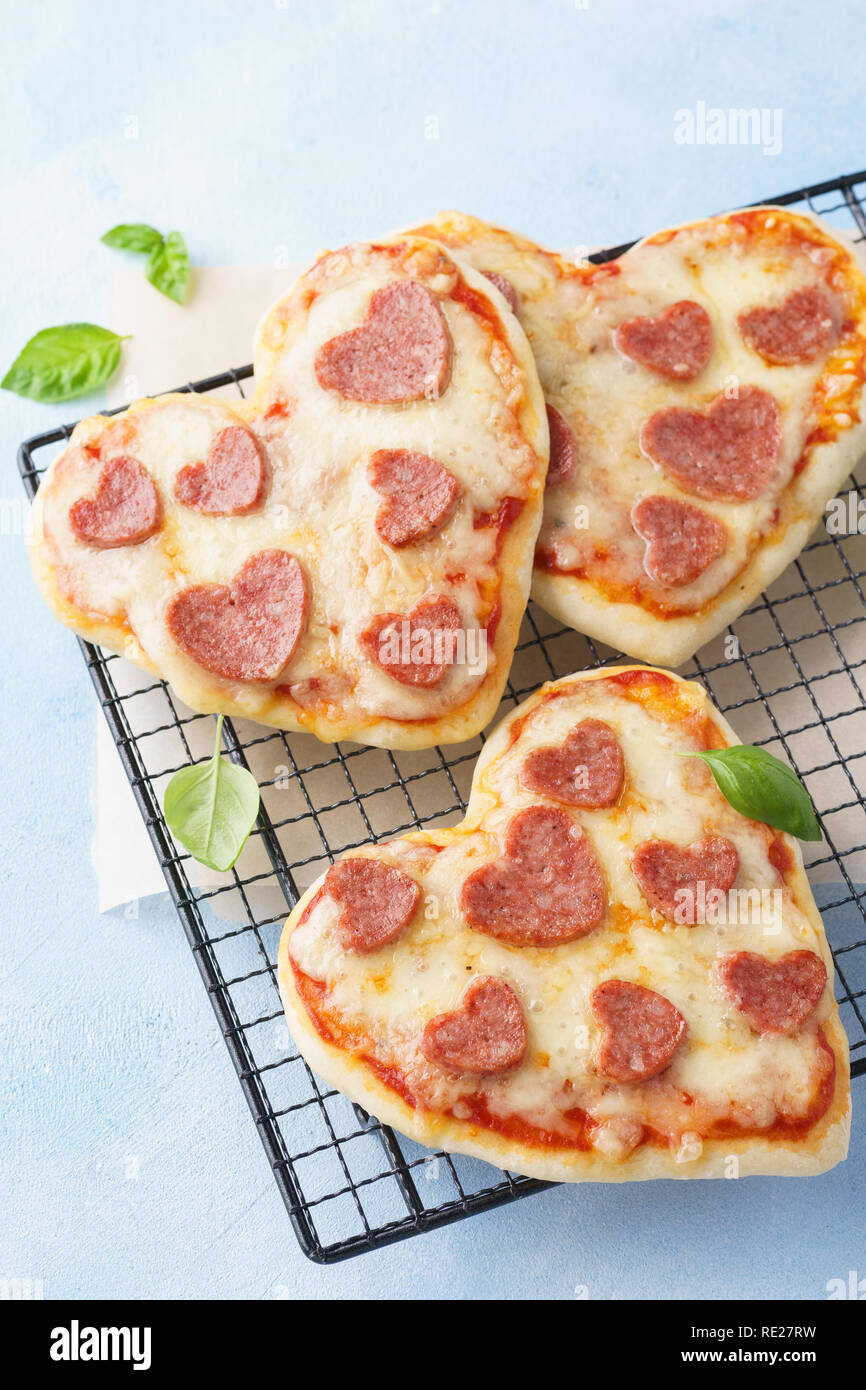 Heart shaped mini pizzas for Valentine's day. Blue background Stock ...