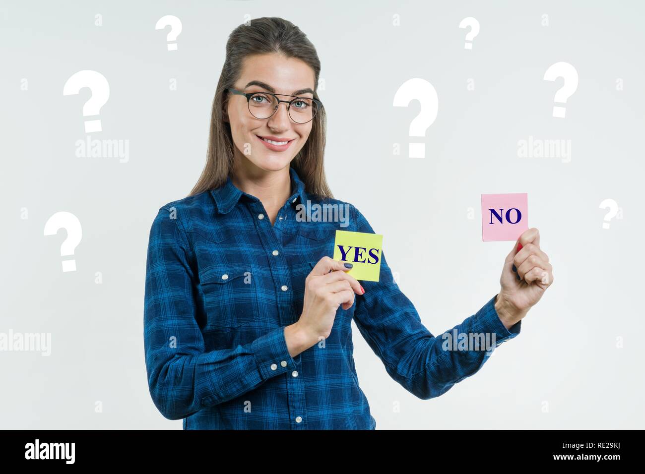 Young attractive female thinking yes or no Stock Photo - Alamy