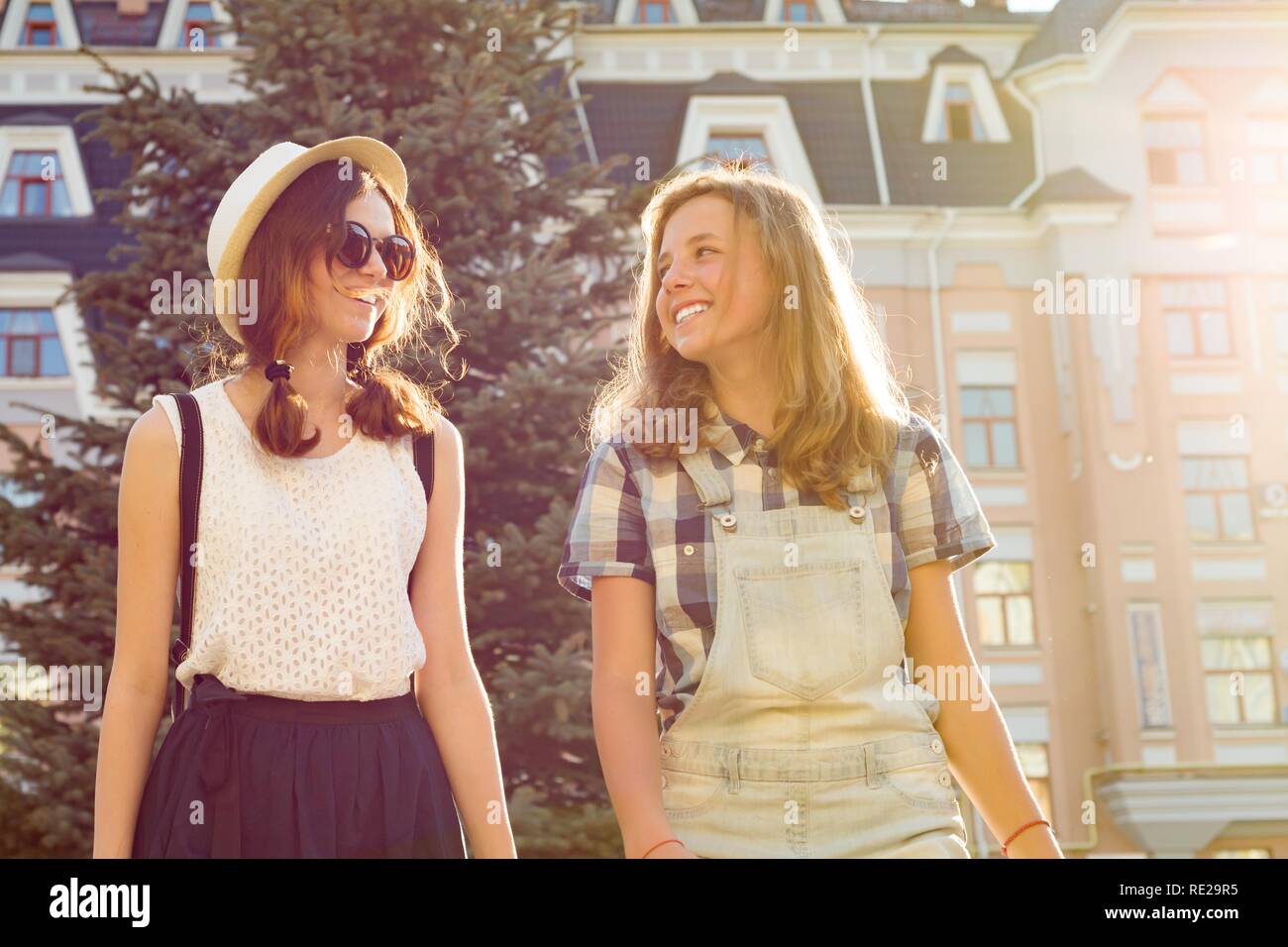 Two young girlfriends are having fun in the city, summer holidays ...